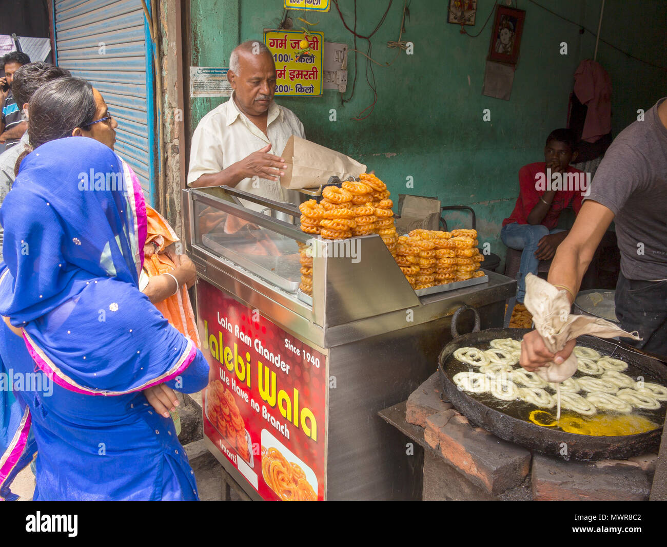 Indian man eating sweet hi-res stock photography and images - Alamy