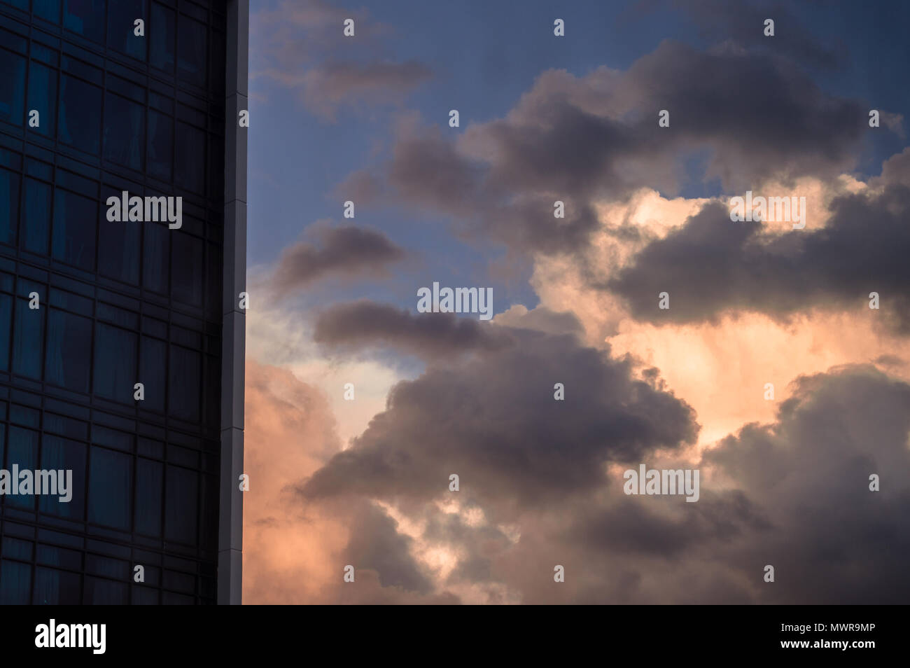 Clouds behind building silhouette at sunset Stock Photo - Alamy