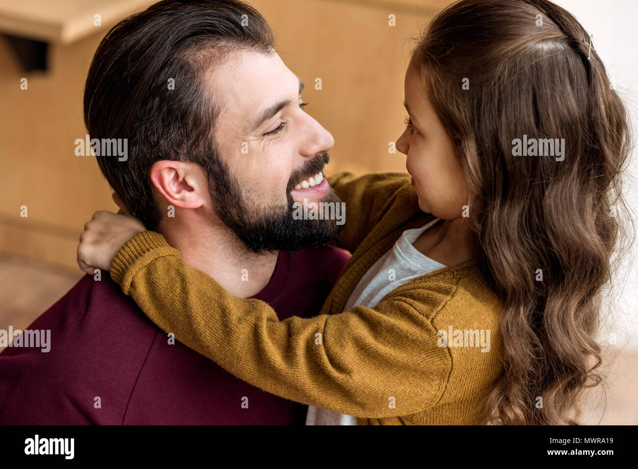 portrait of father and daughter hugging and looking at each other Stock Photo - Alamy
