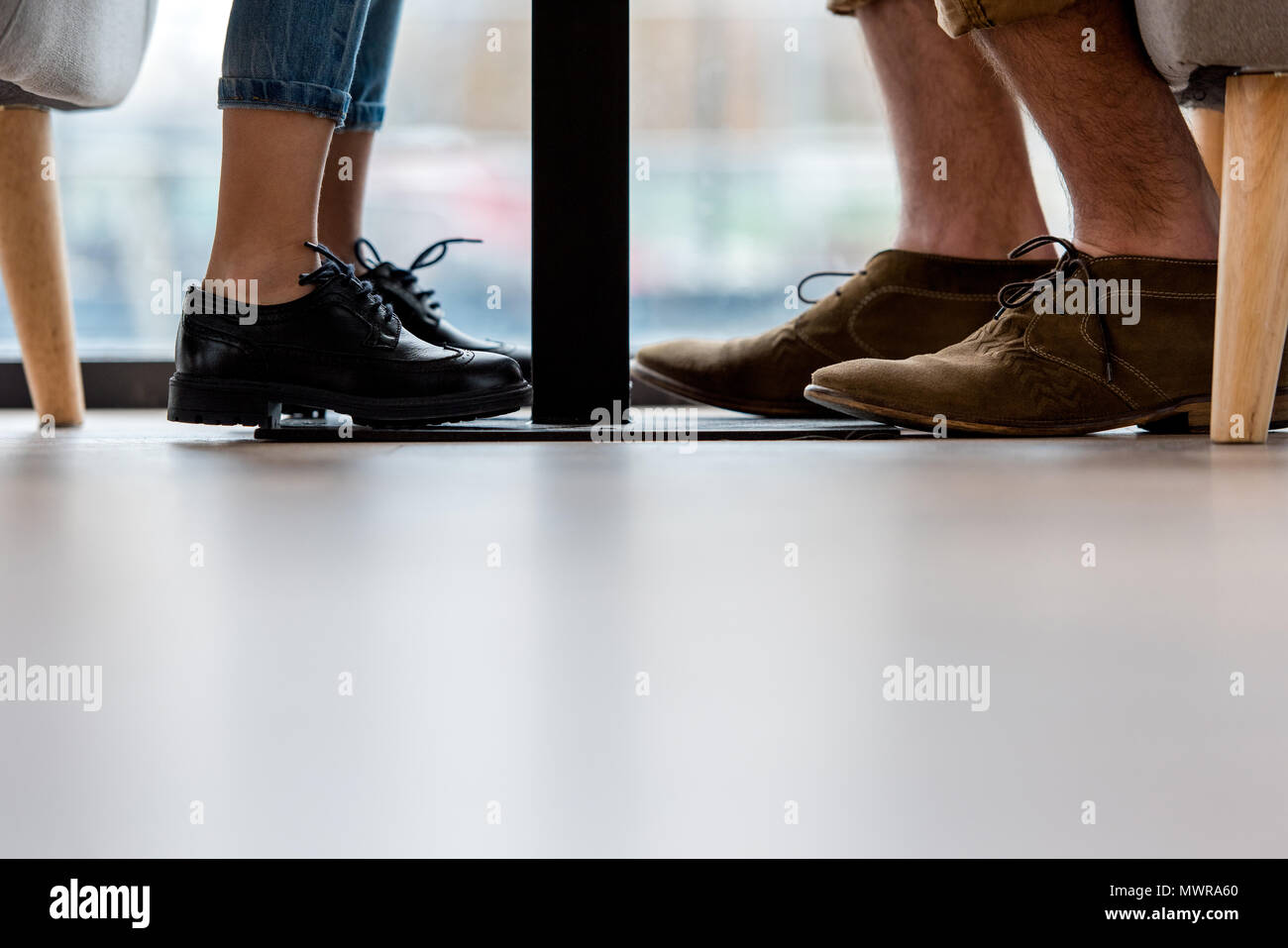 Legs under table hi-res stock photography and images - Alamy