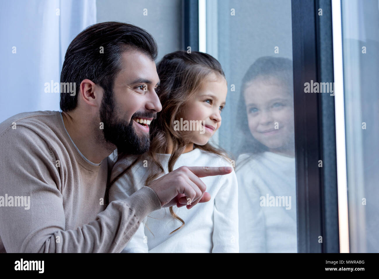 happy father pointing on something and looking away Stock Photo - Alamy