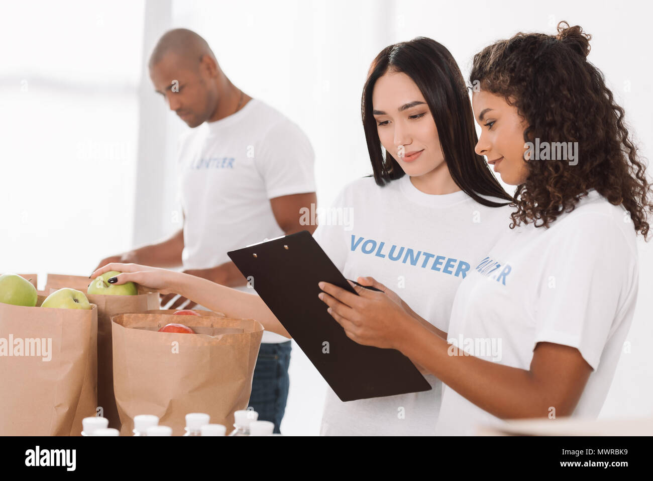 group of young multiethnic volunteers working together Stock Photo - Alamy
