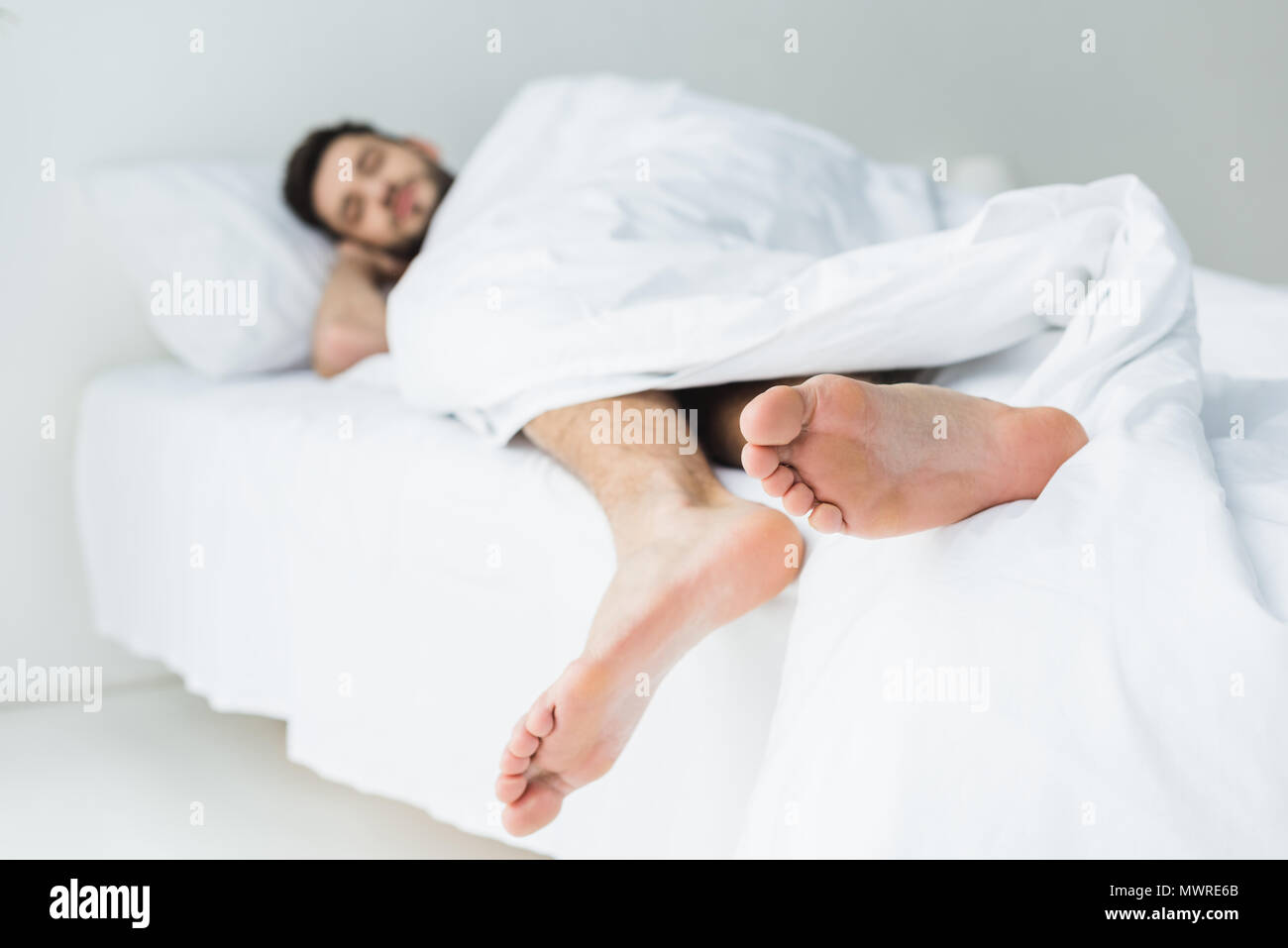 Man sleeping feet on hi-res stock photography and images - Alamy