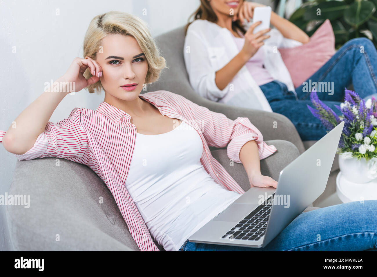 beautiful women using laptop and smartphone at home Stock Photo - Alamy