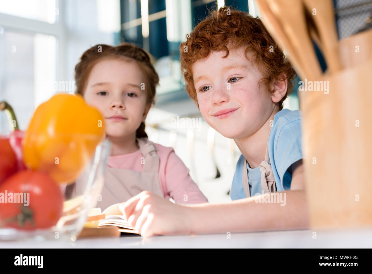 selective focus of cute little kids cooking together in kitchen Stock ...
