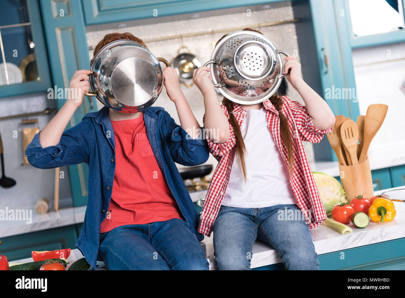 cute little children having fun with utensils in kitchen Stock Photo ...