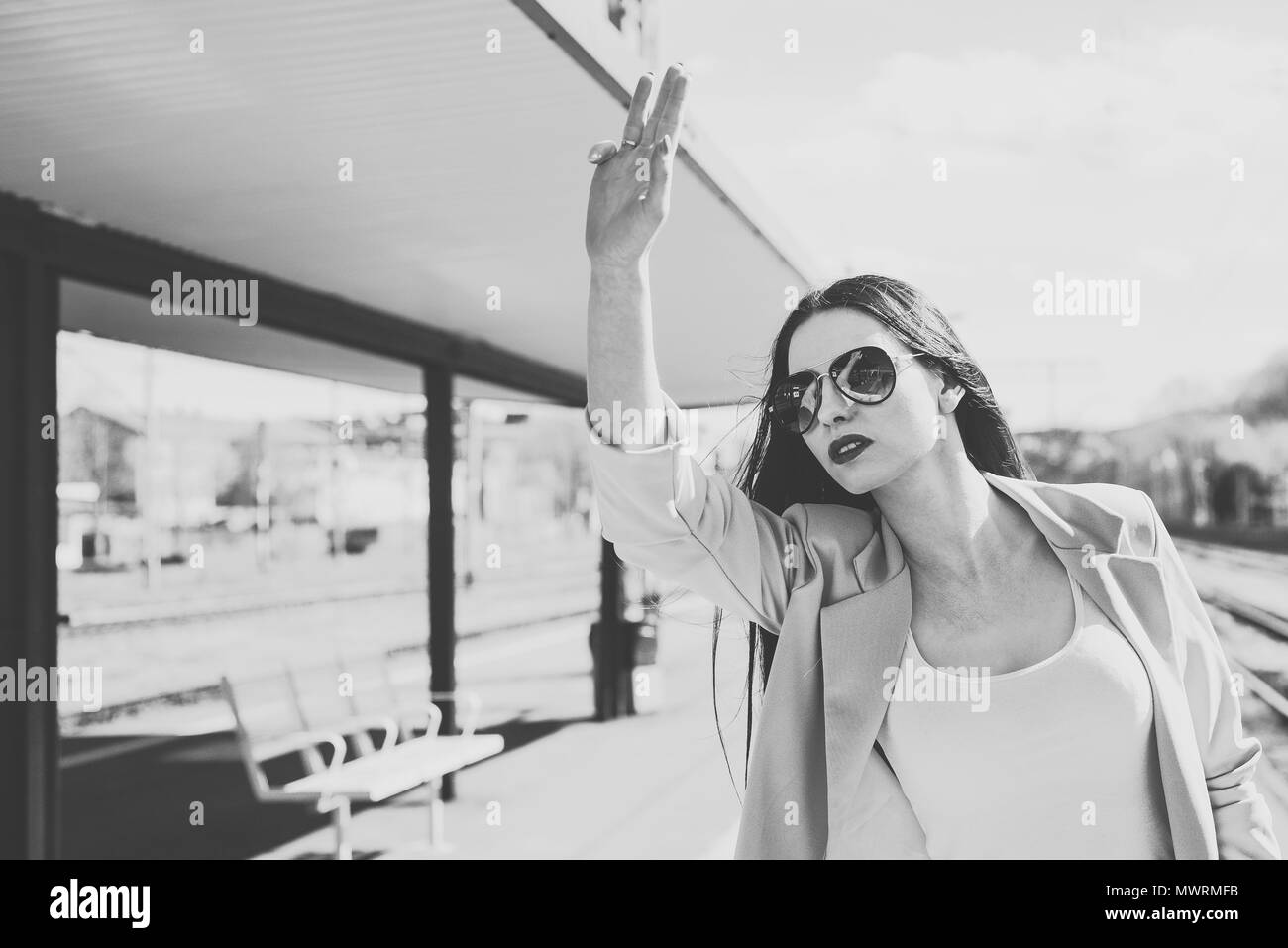 Vintage look at a woman calling friends. The woman on the platform ...