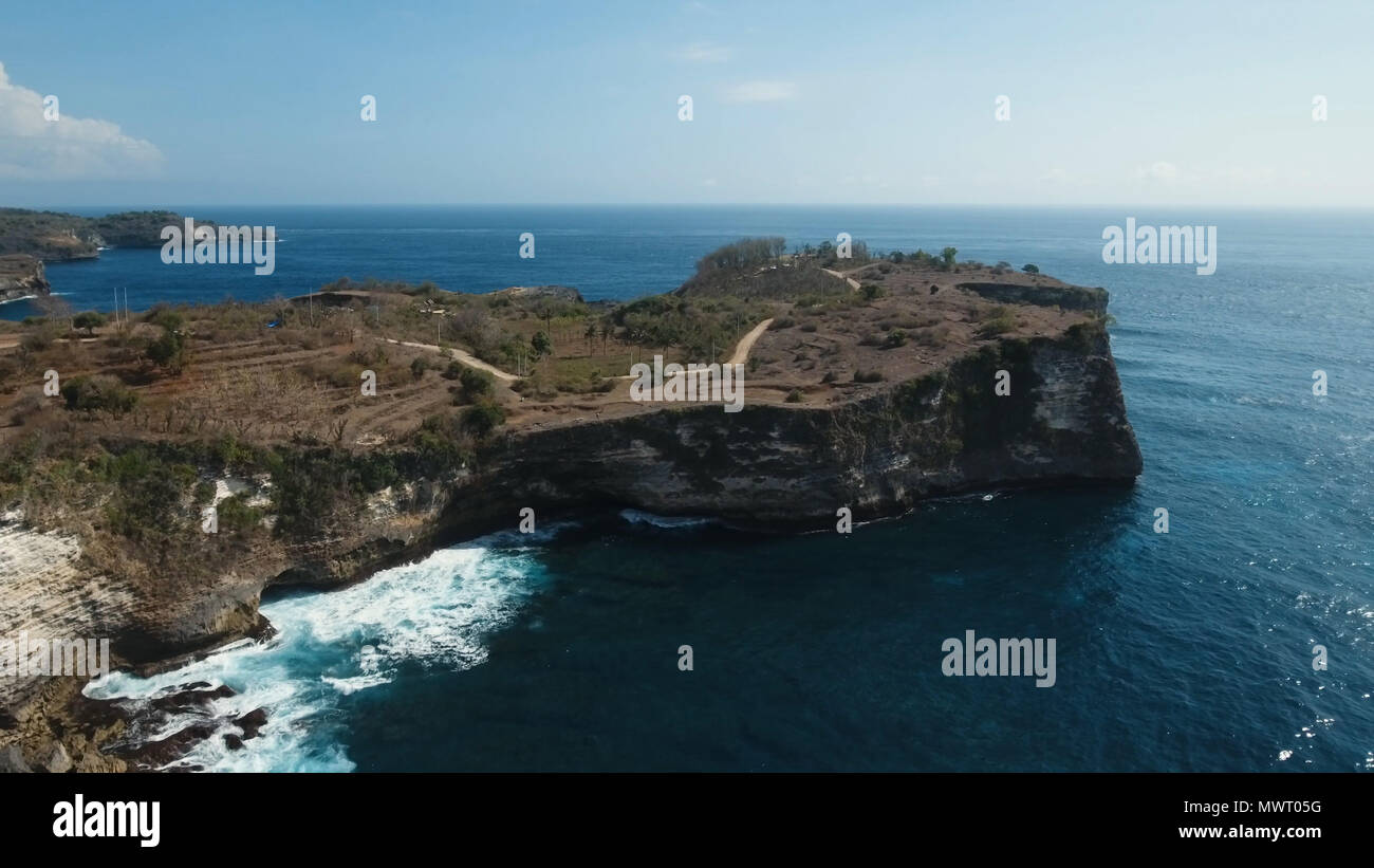 Aerial view of Rocky coast with high cliffs, sea surf with breaking ...