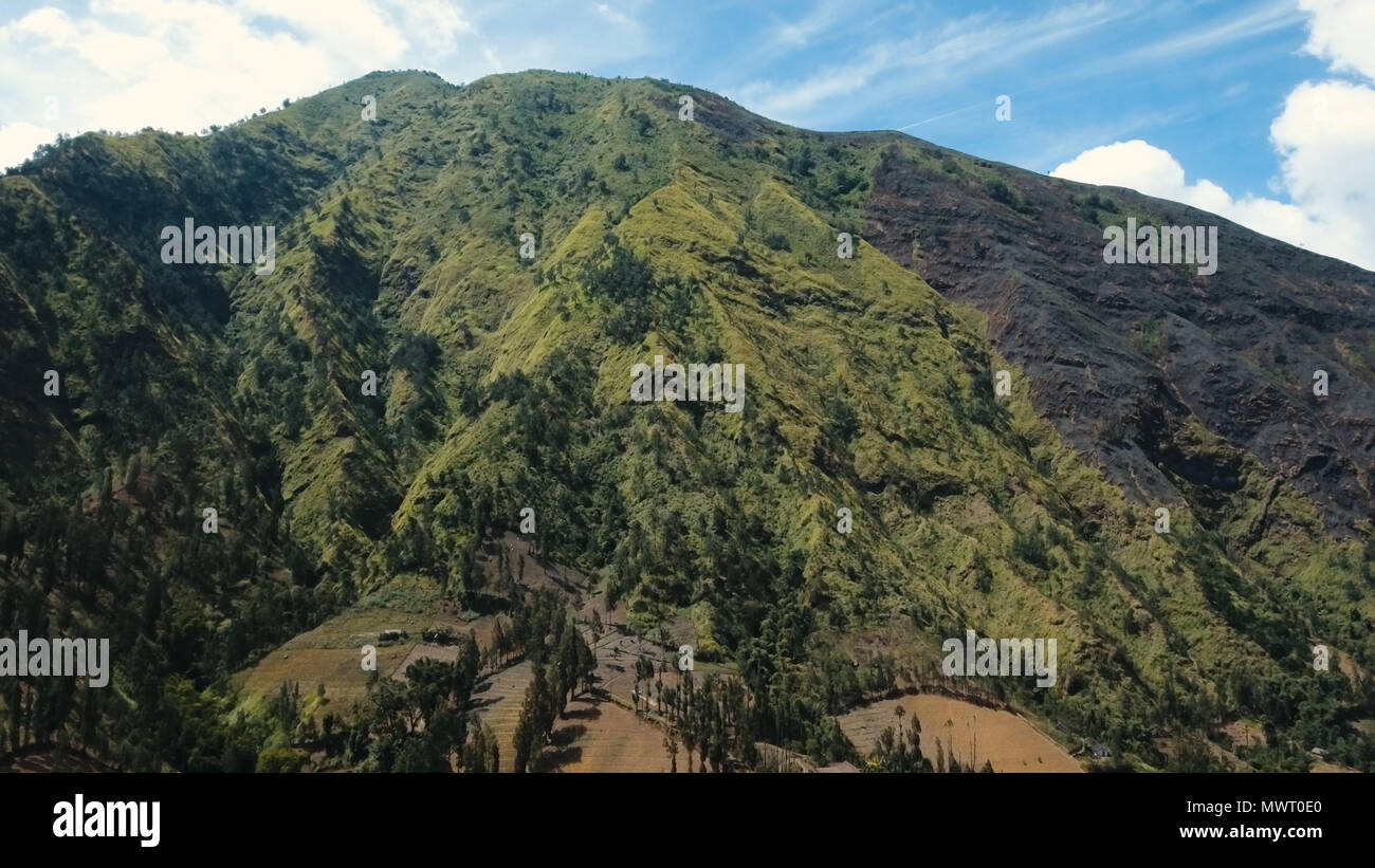 Aerial view Slopes of mountains covered with green tropical forest.Jawa ...