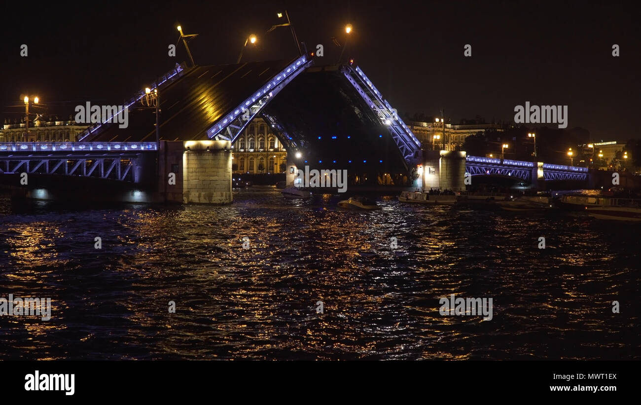 Opening drawbridge. Bridge over the river, illuminating the water with ...