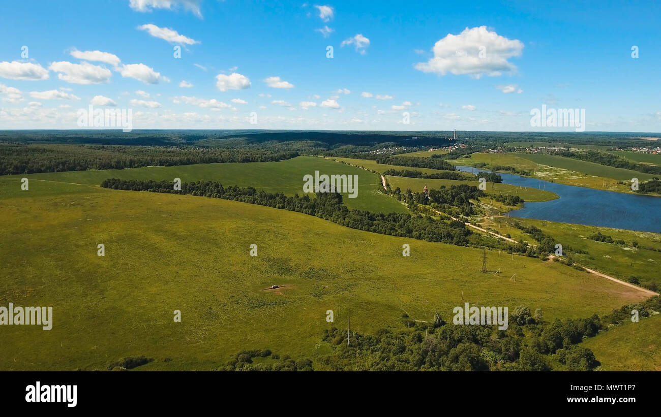 Aerial View Flying over the lake and green fields Stock Photo - Alamy