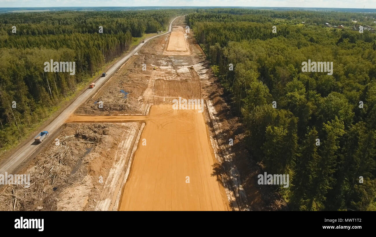 Construction of a new road in the forest area. Aerial view construction ...