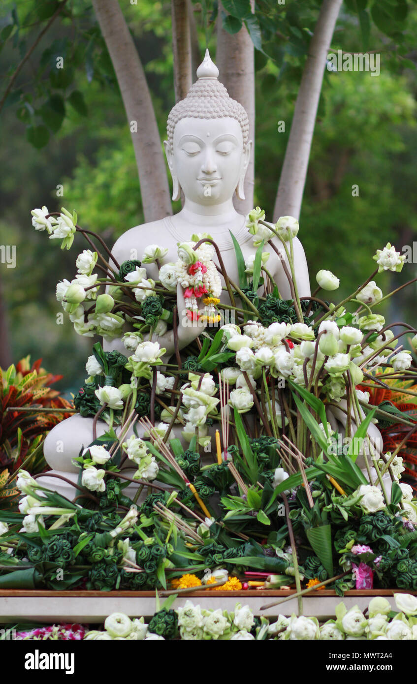 Buddhism worship with offering flowers and garland to buddha statue on ...