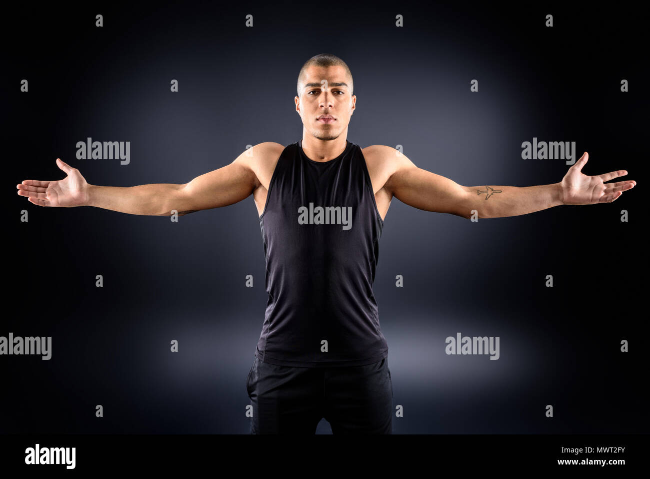 african american sportsman with outstretched arms on black Stock Photo ...