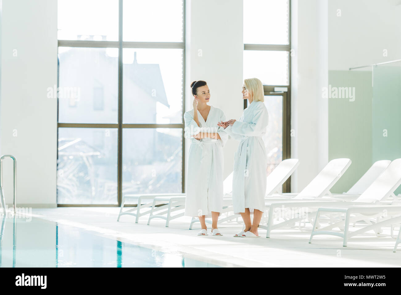 Young Women Talking In Swimming Pool High Resolution Stock Photography ...