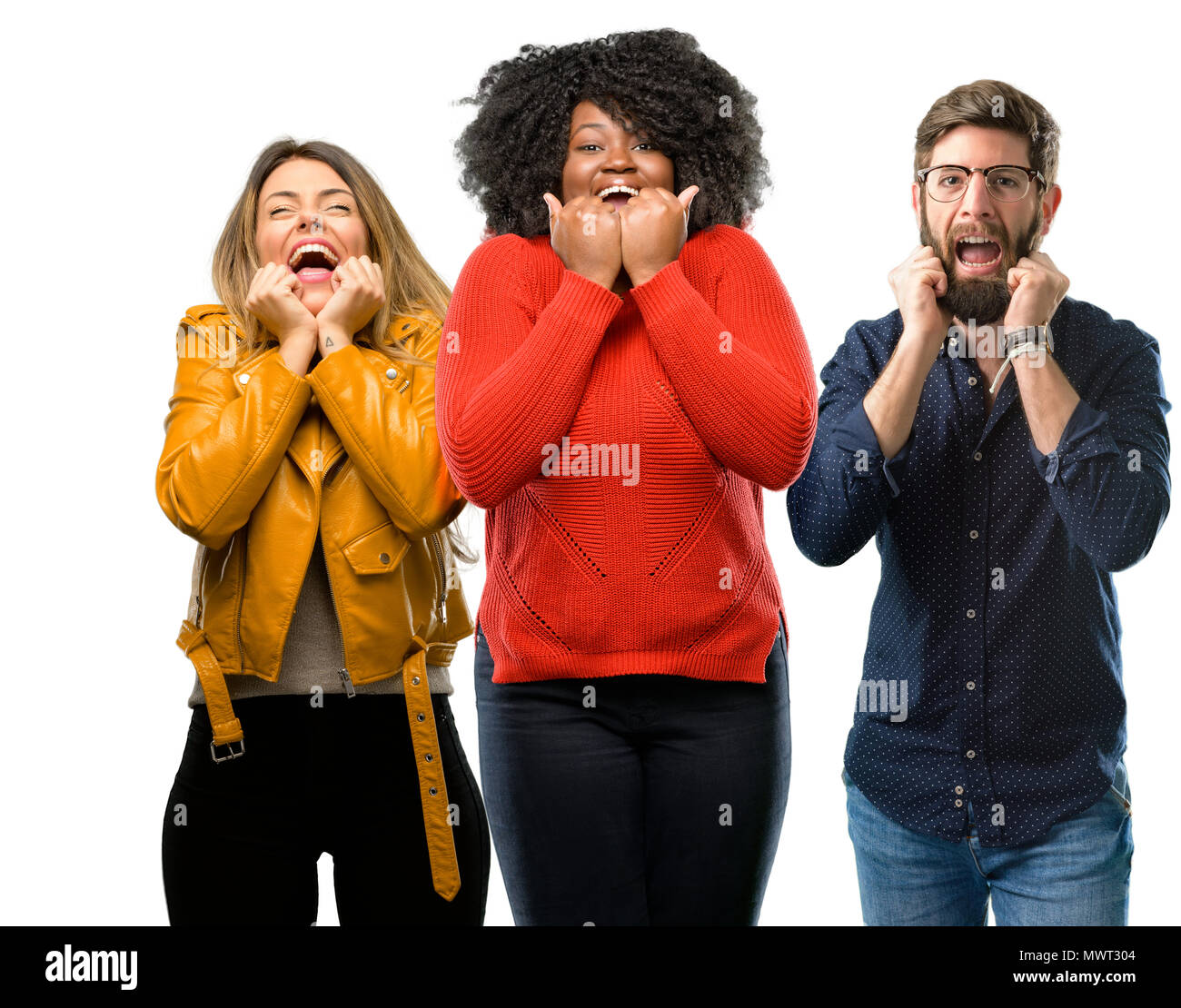 Group of three young men and women happy and surprised cheering ...
