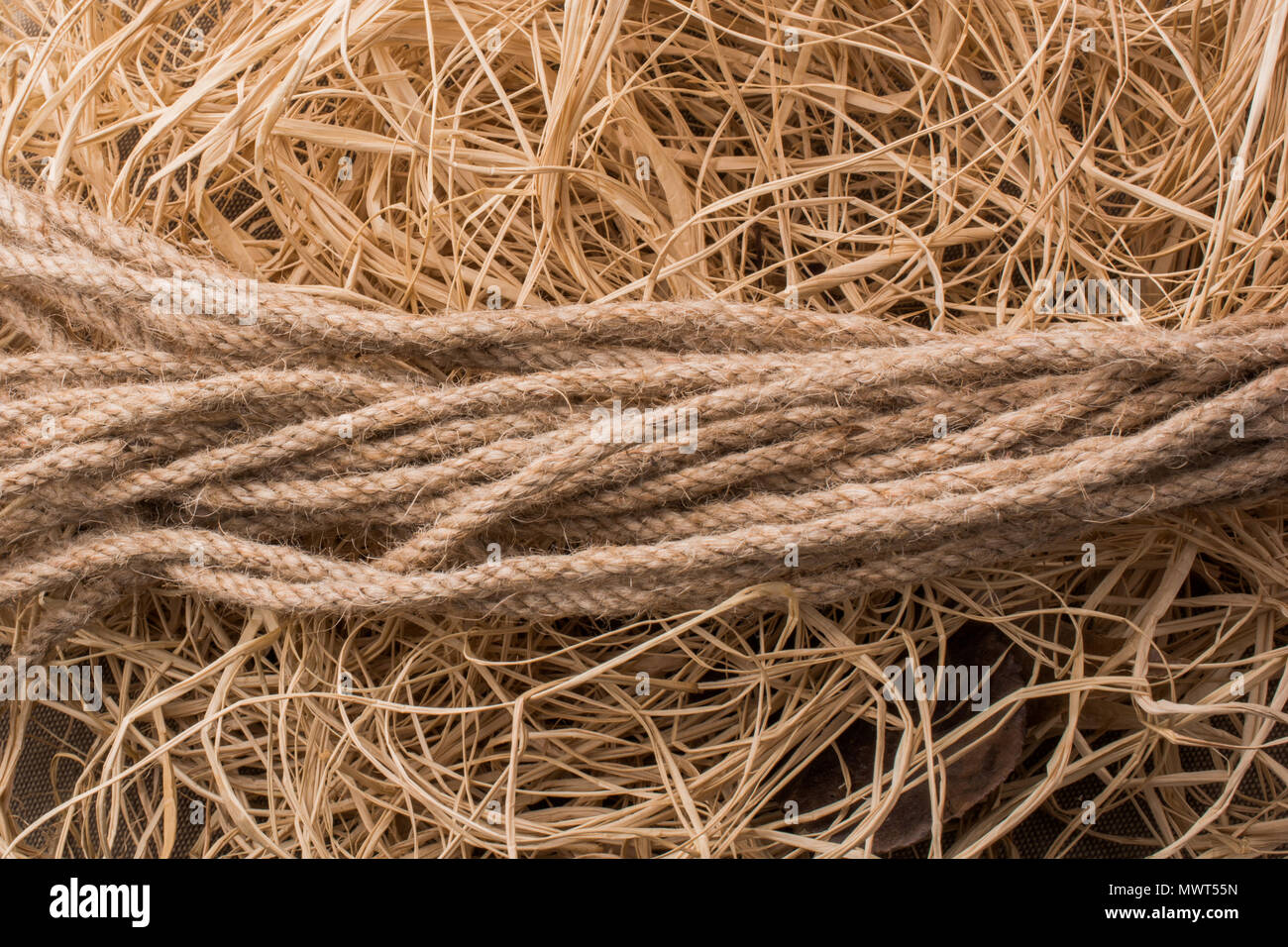 Bundle of linen rope in a straw background Stock Photo - Alamy