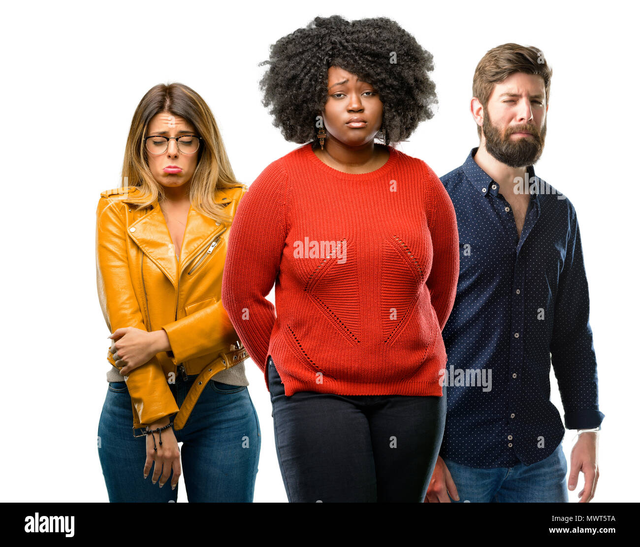 Group of three young men and women with sad and upset expression ...