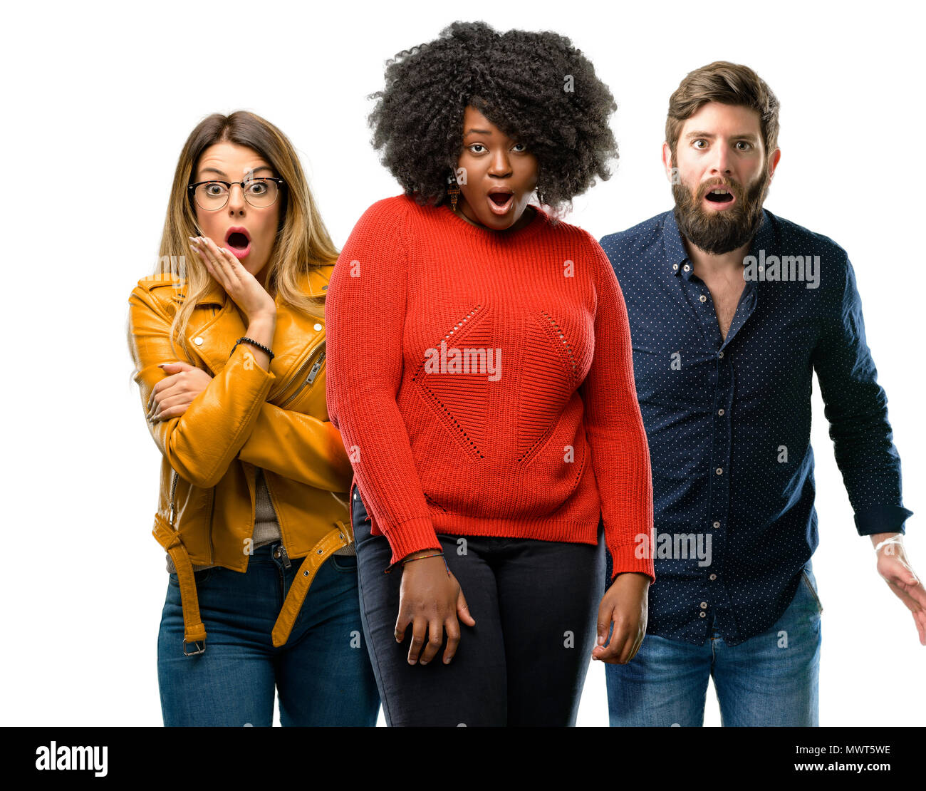 Group of three young men and women happy and surprised cheering ...