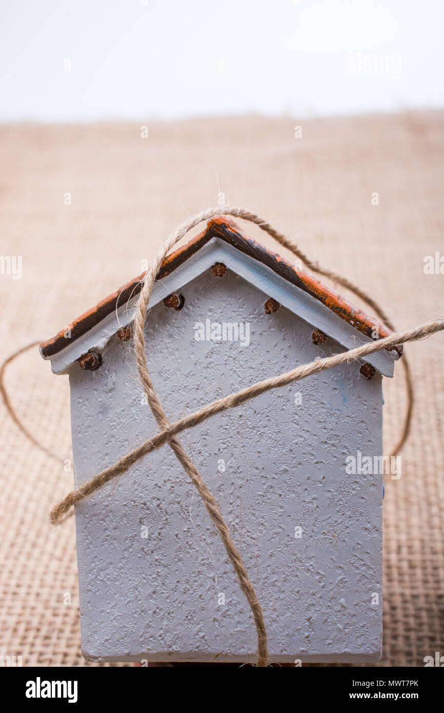 Thread wrapped around a model house on a brown background Stock Photo ...
