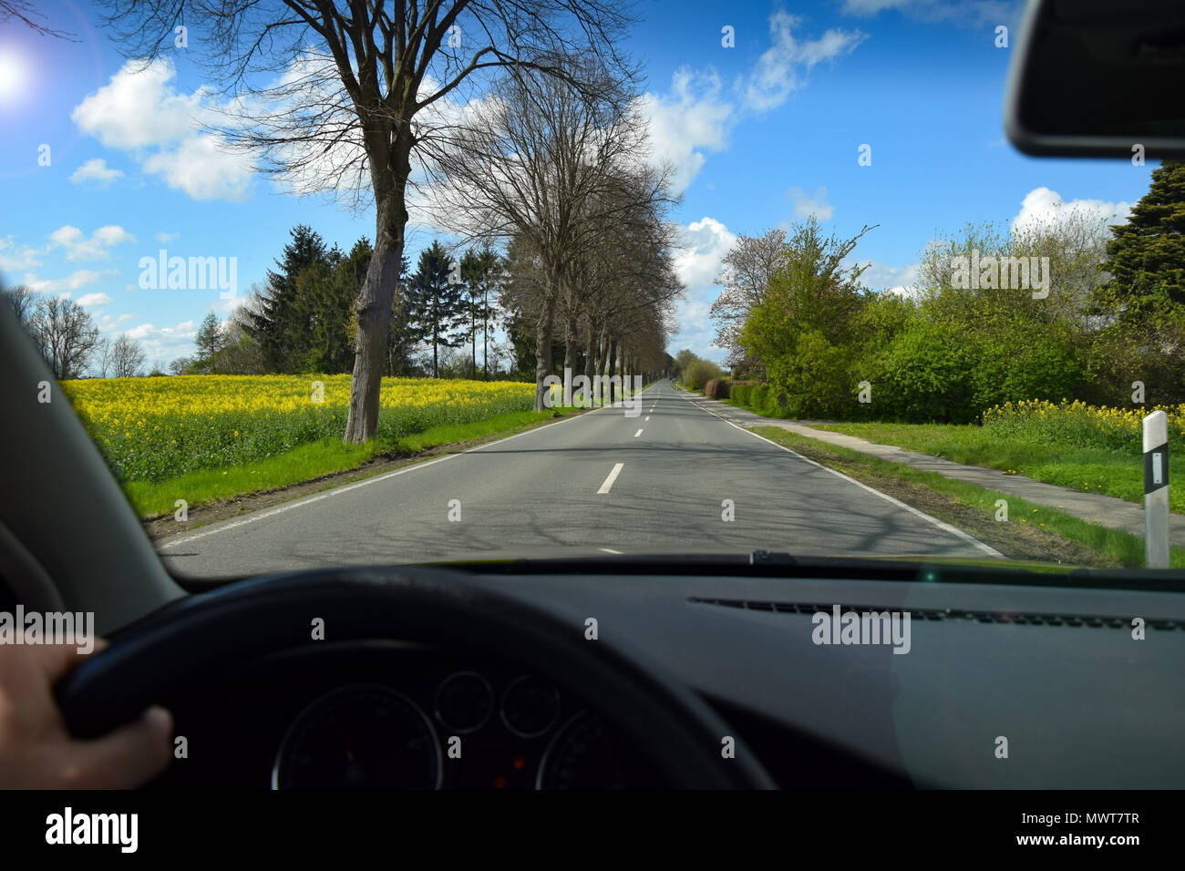 Car driving through spring landscape on country road Stock Photo - Alamy