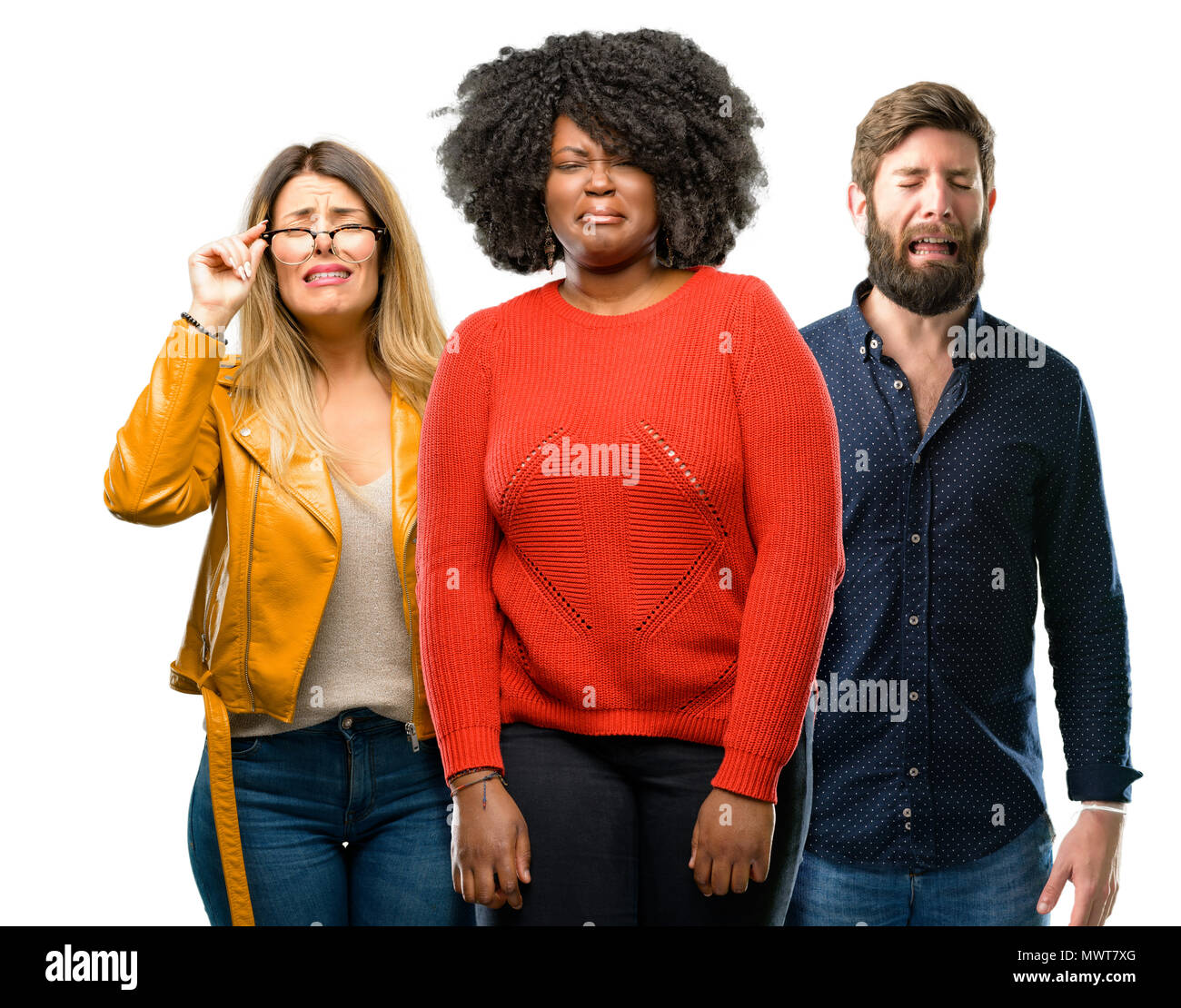 Group of three young men and women crying depressed full of sadness ...