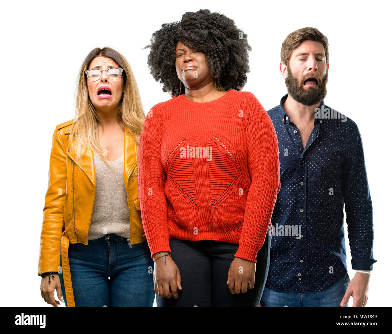 Group of three young men and women crying depressed full of sadness ...