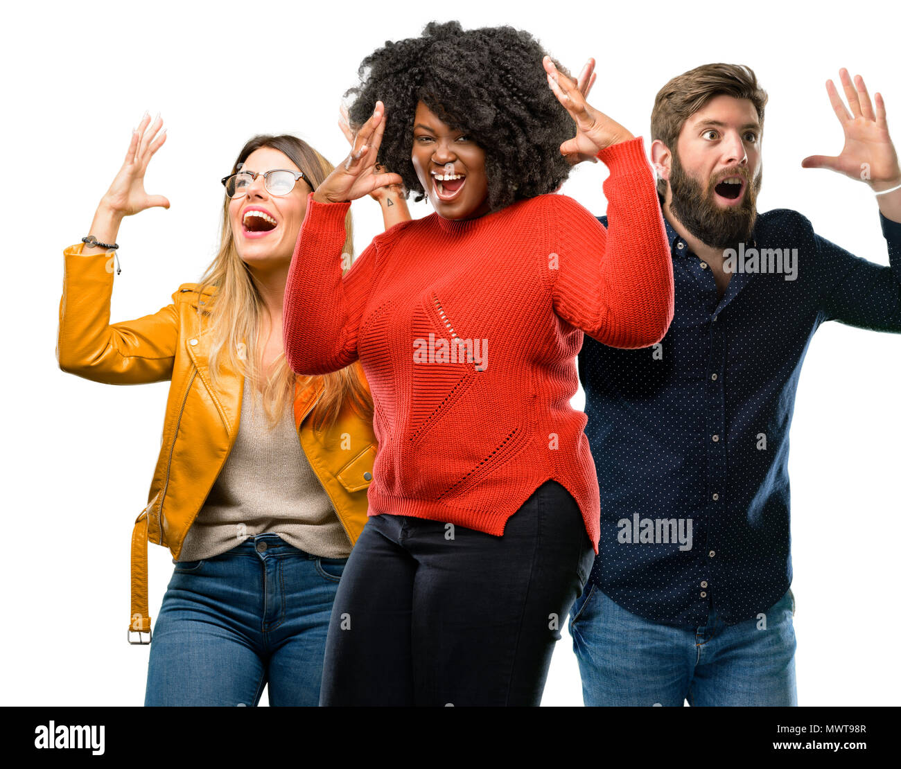 Group of three young men and women happy and surprised cheering ...