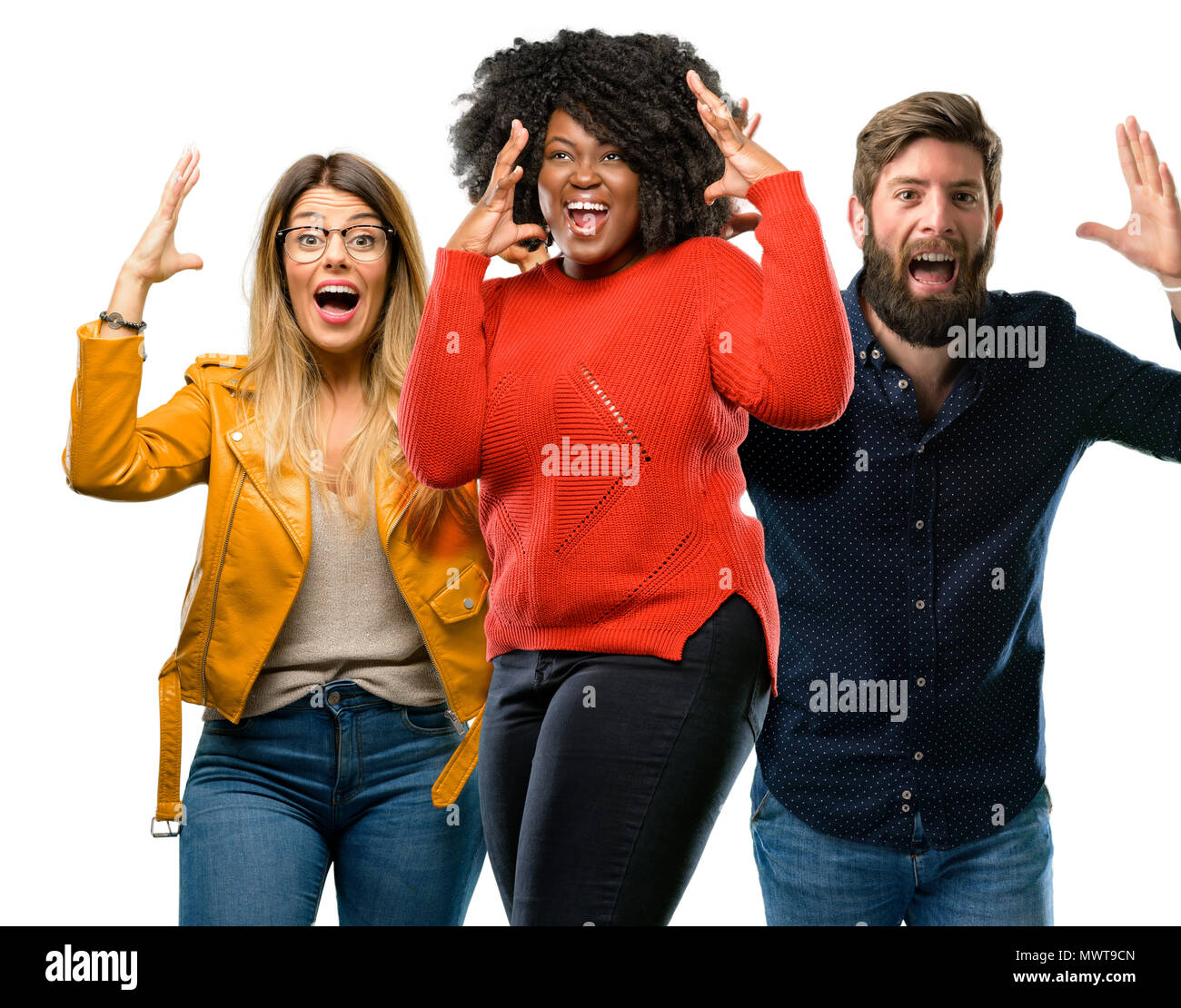 Group of three young men and women happy and surprised cheering ...