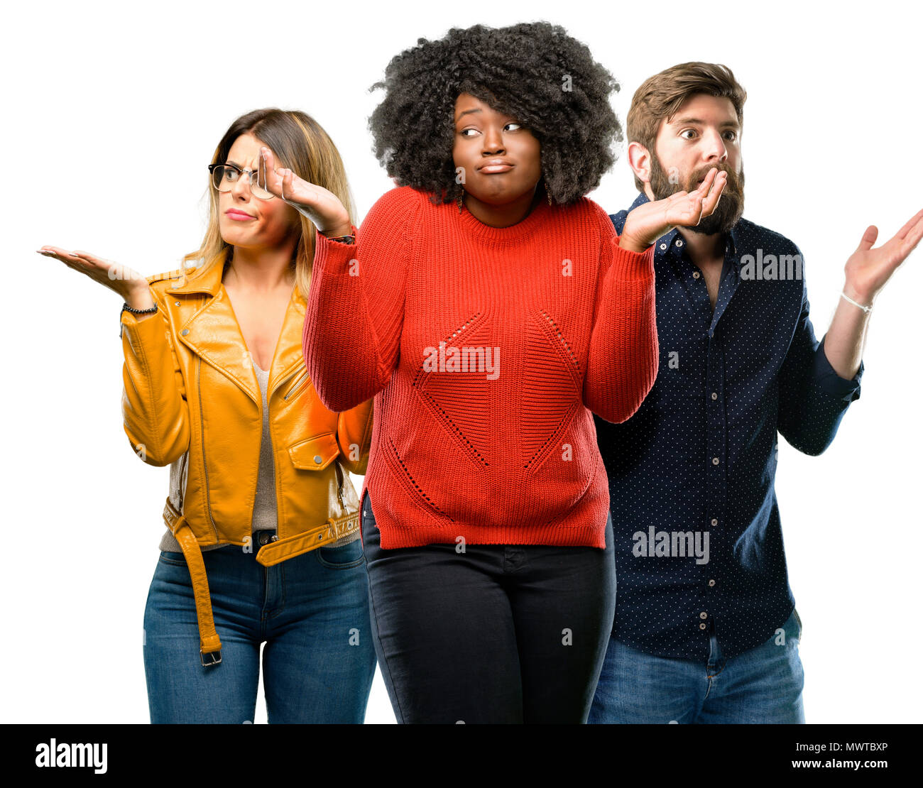 Group of three young men and women doubt expression, confuse and wonder ...