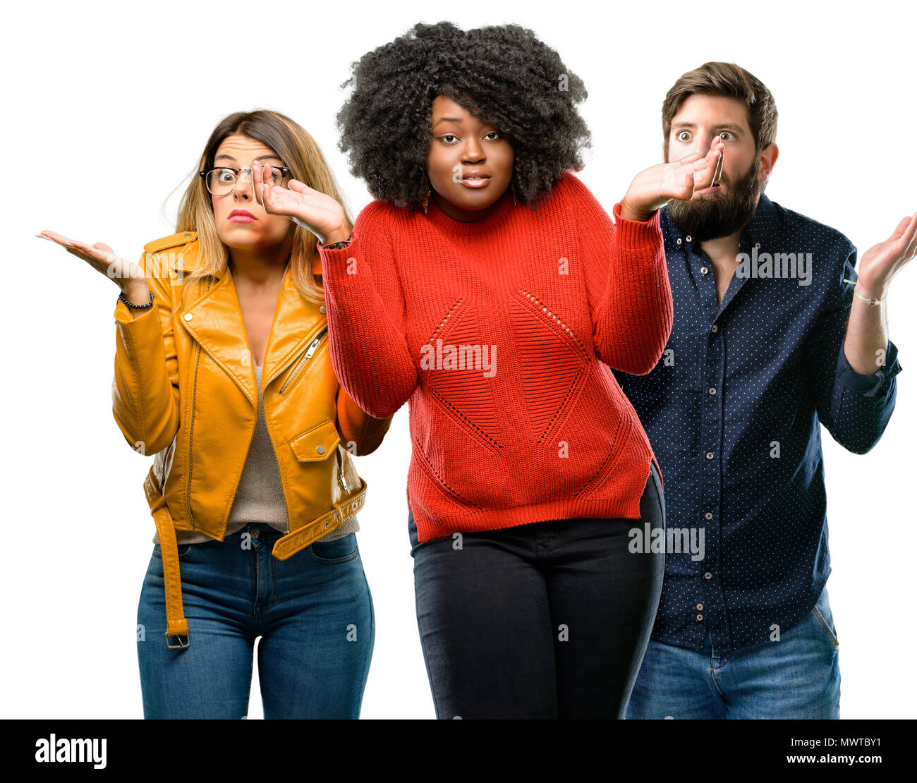 Group of three young men and women doubt expression, confuse and wonder ...