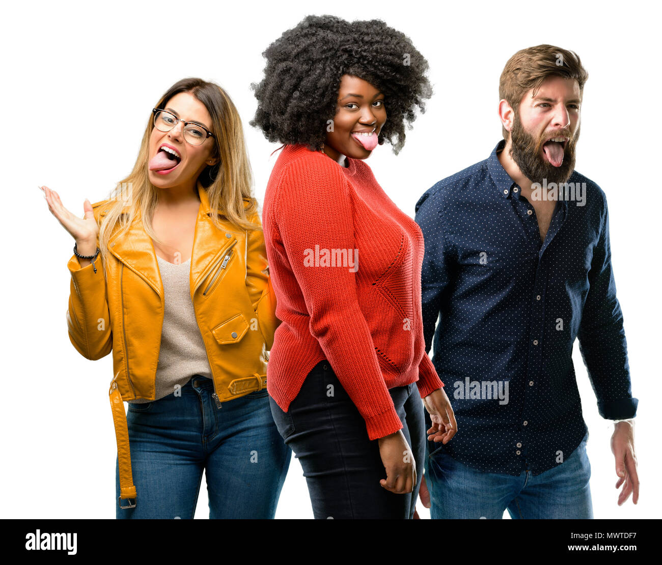 Group of three young men and women sticking out tongue at camera at ...