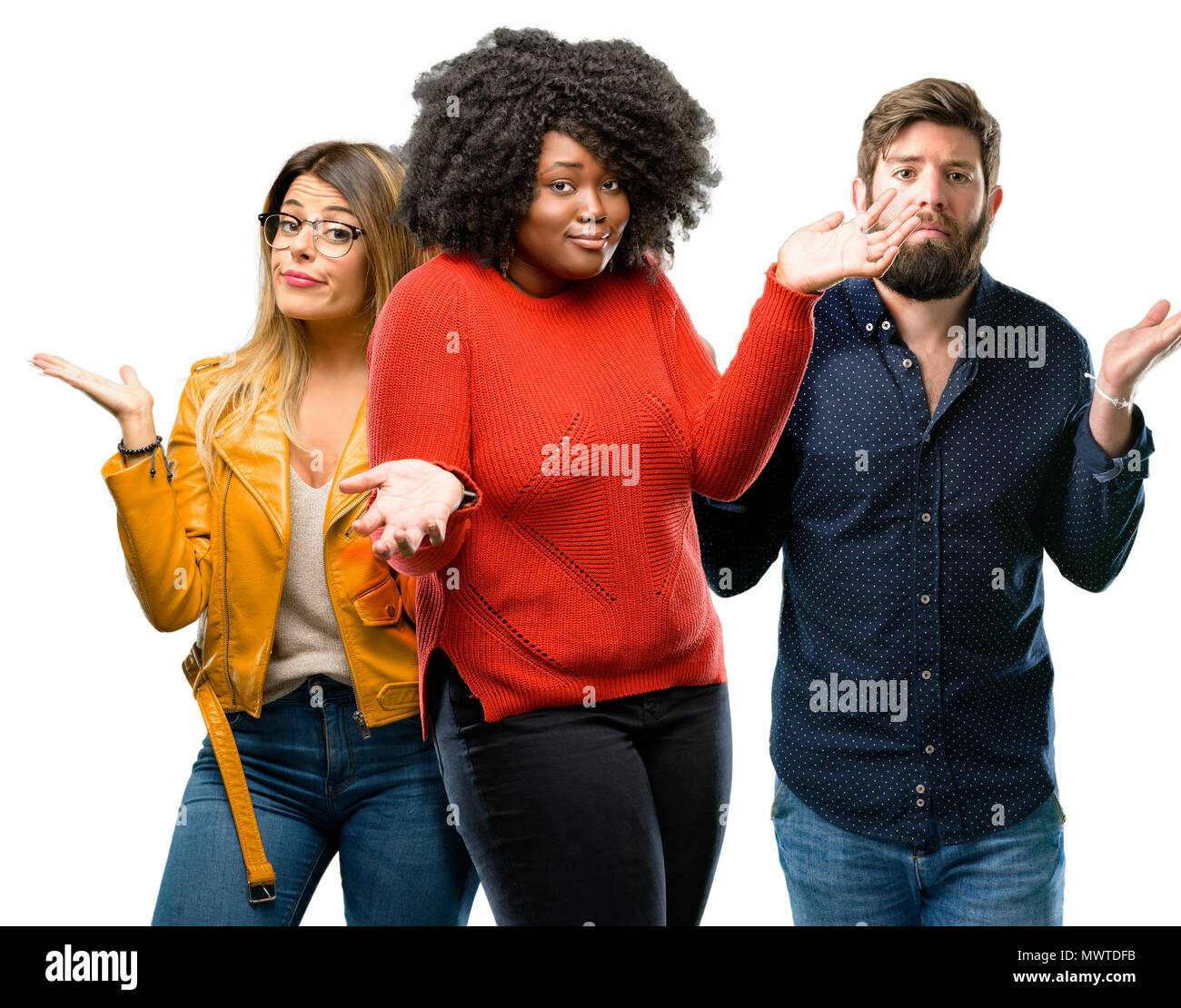 Group of three young men and women doubt expression, confuse and wonder ...