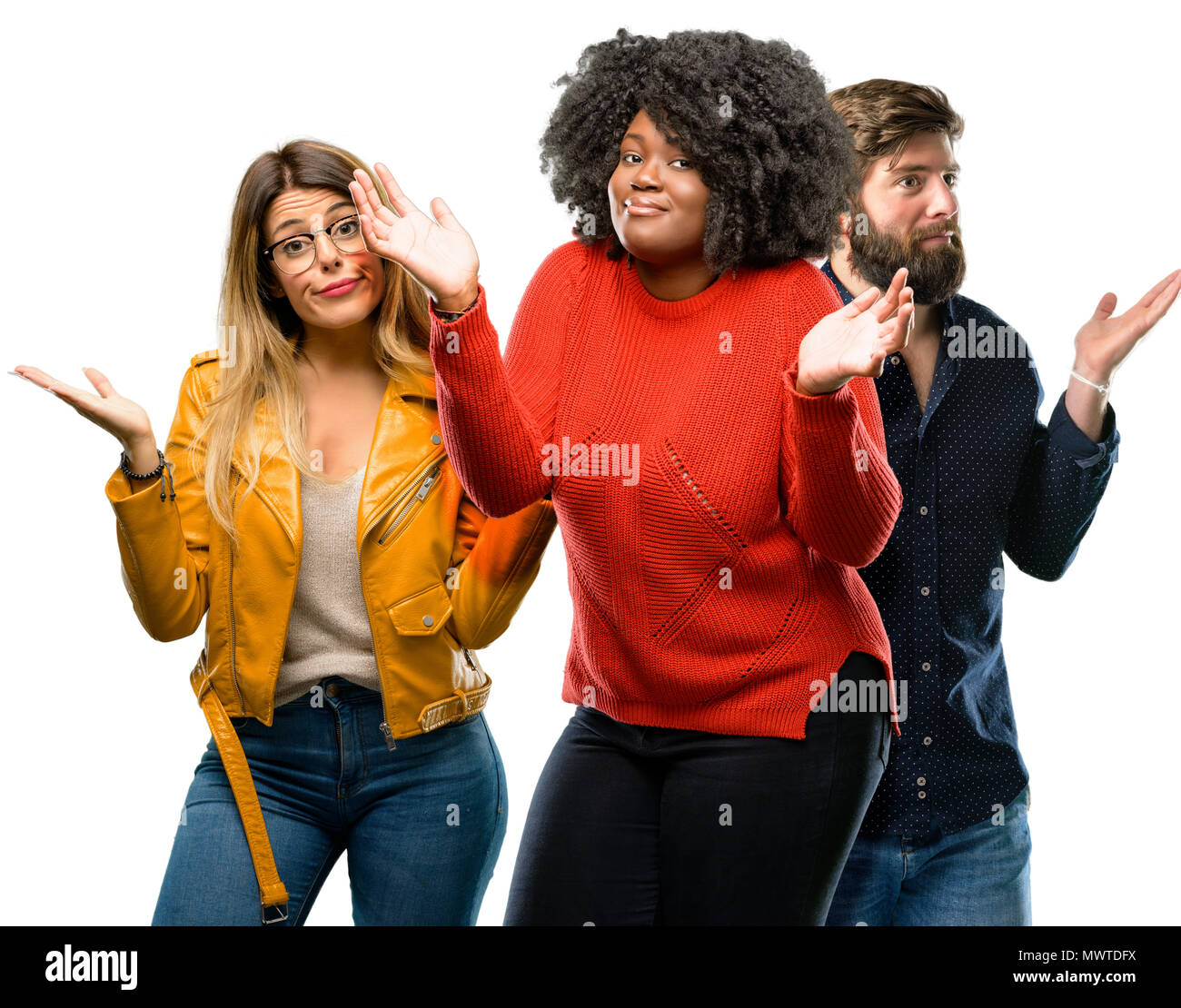 Group of three young men and women doubt expression, confuse and wonder ...