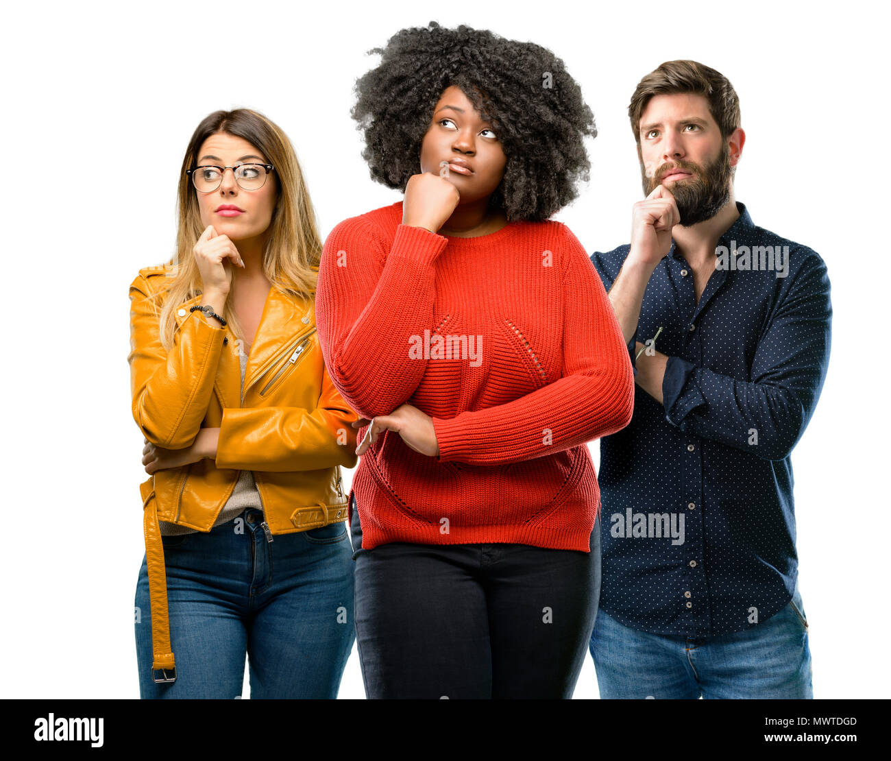 Group of three young men and women thinking and looking up expressing ...