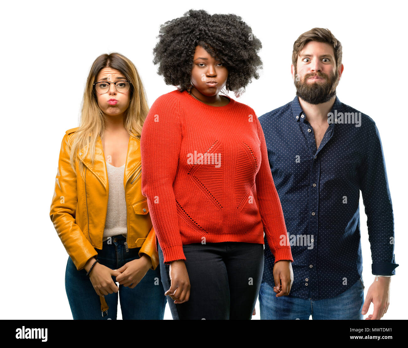 Group of three young men and women puffing out cheeks, having fun ...
