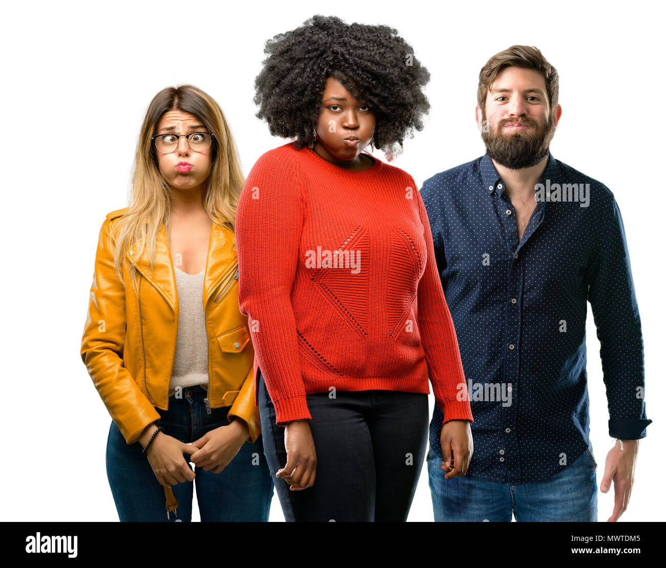 Group of three young men and women puffing out cheeks, having fun ...