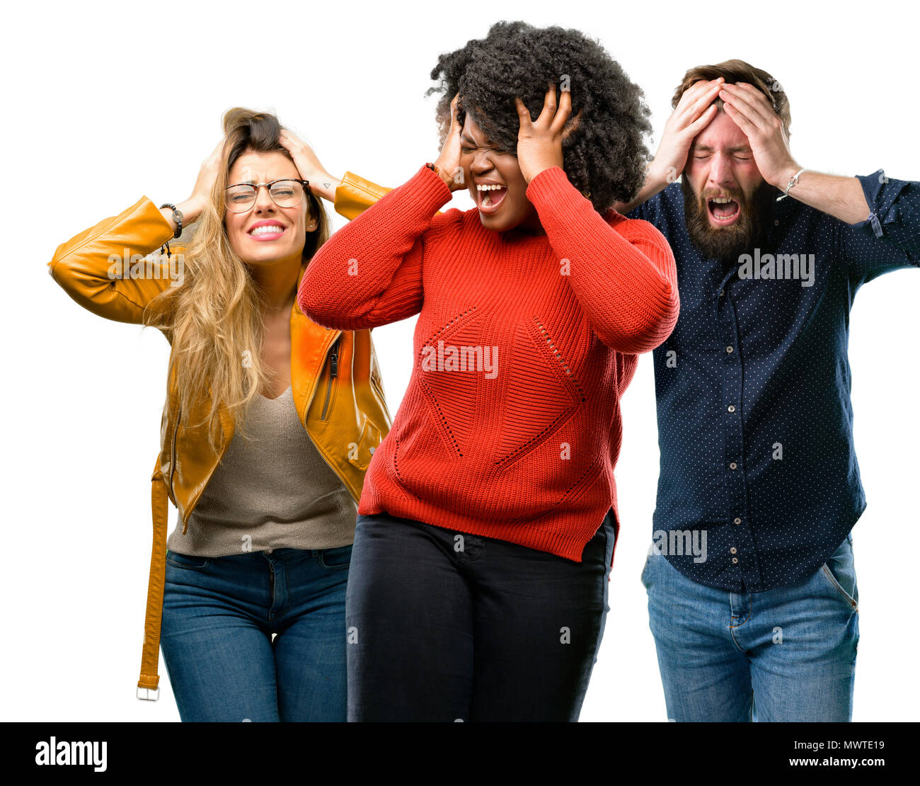 Group of three young men and women stressful keeping hands on head ...