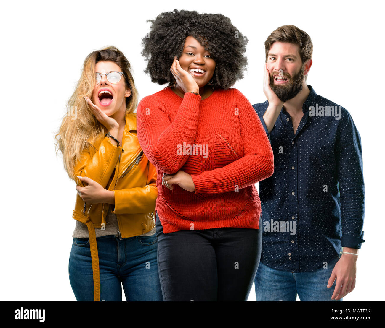 Group of three young men and women happy and surprised cheering ...