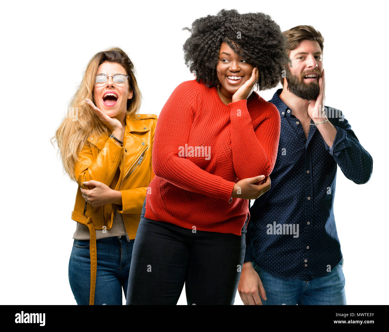 Group of three young men and women happy and surprised cheering ...