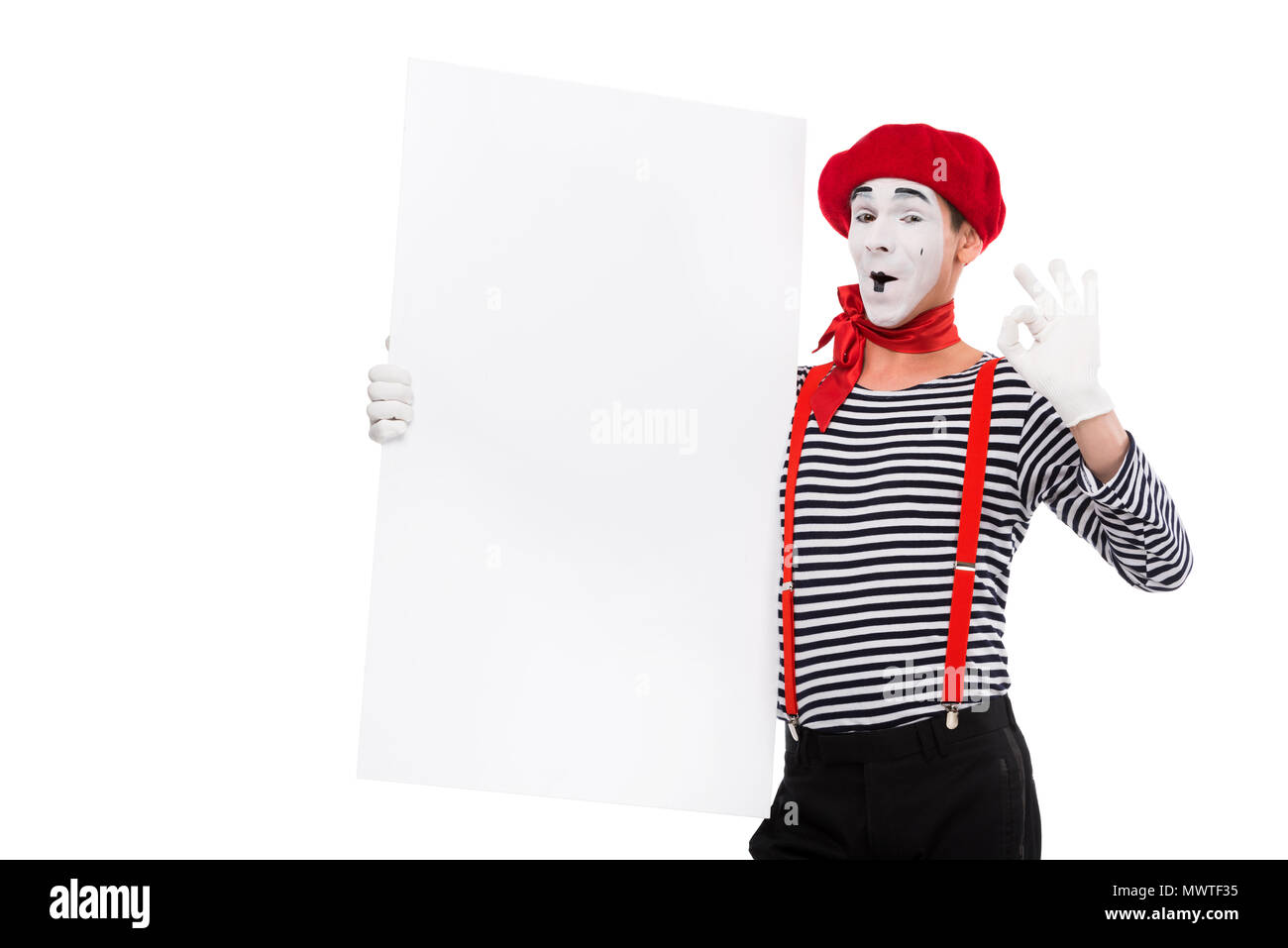 happy mime holding empty board and showing ok sign isolated on white ...