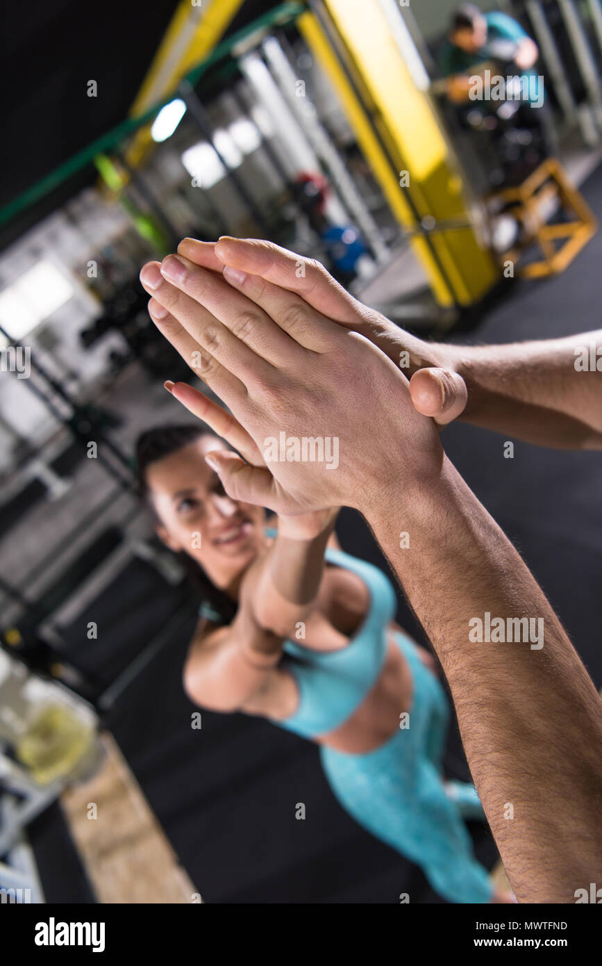 group of young athletes making high five after hard exercise at cross ...
