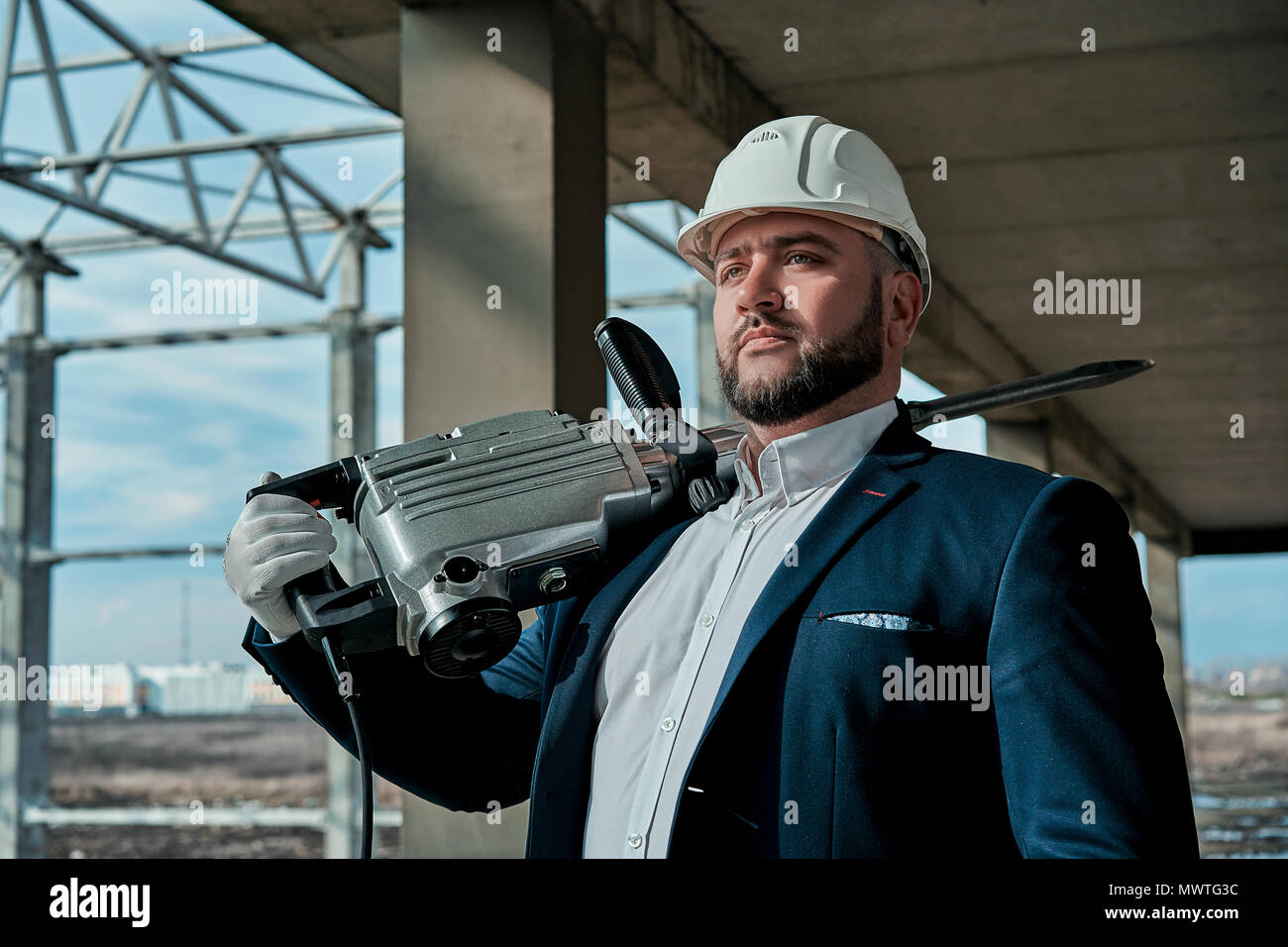 man in a helmet on the construction site Stock Photo - Alamy