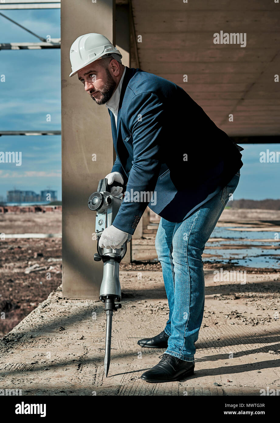 man in a helmet on the construction site Stock Photo - Alamy