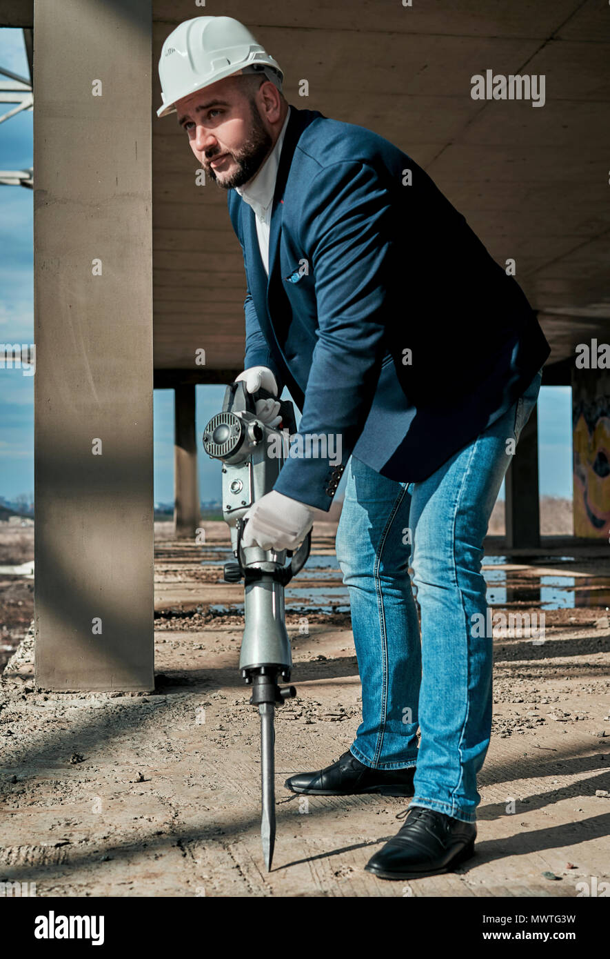 man in a helmet on the construction site Stock Photo - Alamy