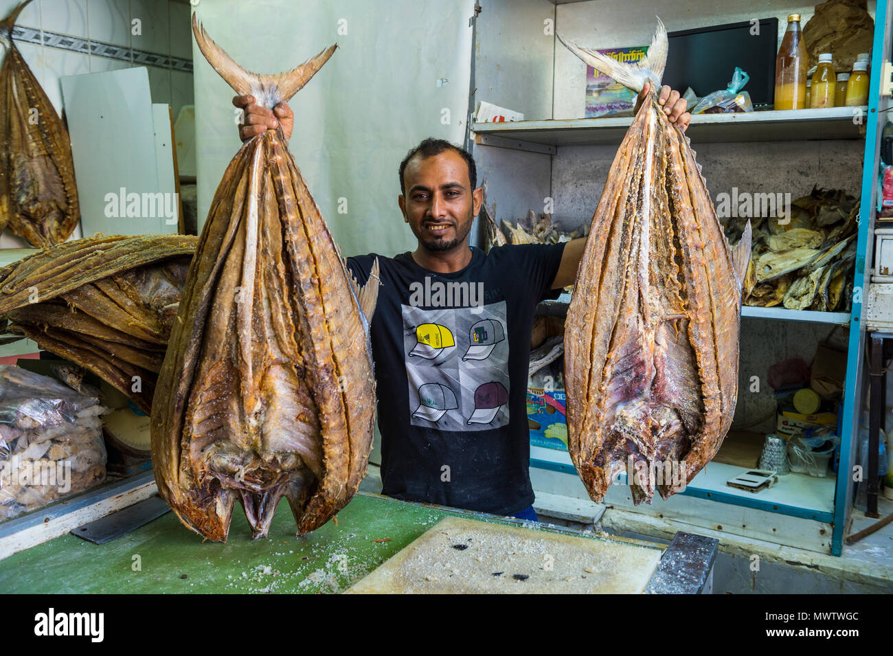 Man selling a huge dried fish, Jemenite market, Jeddah, Saudi Arabia ...