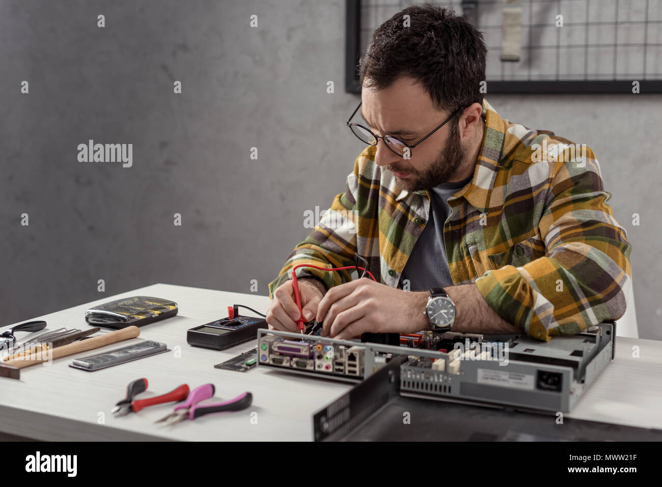 repairman using multimeter while fixing computer Stock Photo - Alamy
