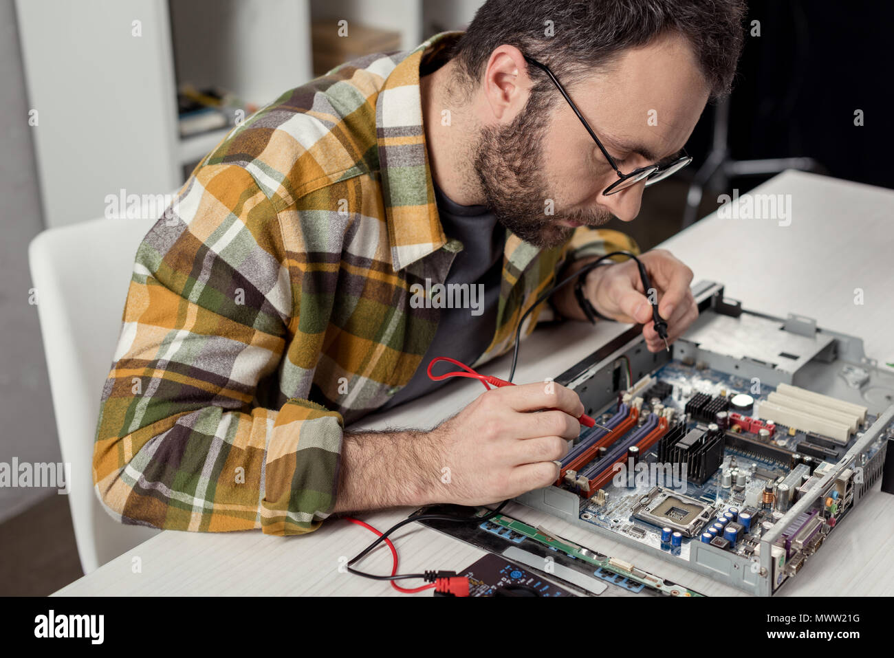 man using multimeter while fixing computer motherboard Stock Photo - Alamy