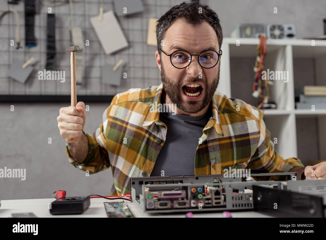 Angry repairman hammer in hi-res stock photography and images - Alamy