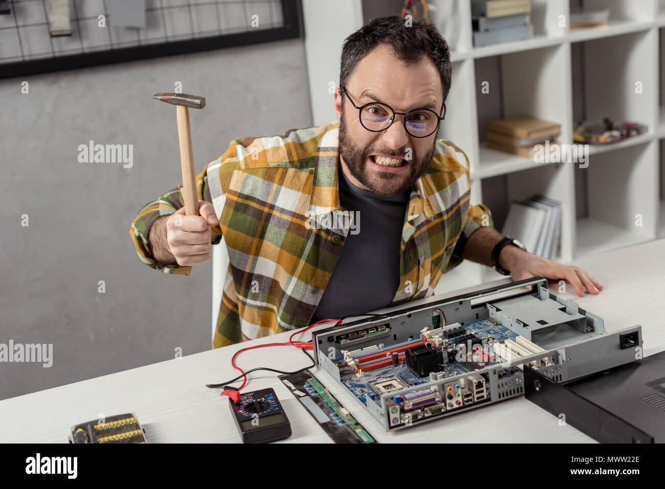 Angry repairman hammer in hi-res stock photography and images - Alamy